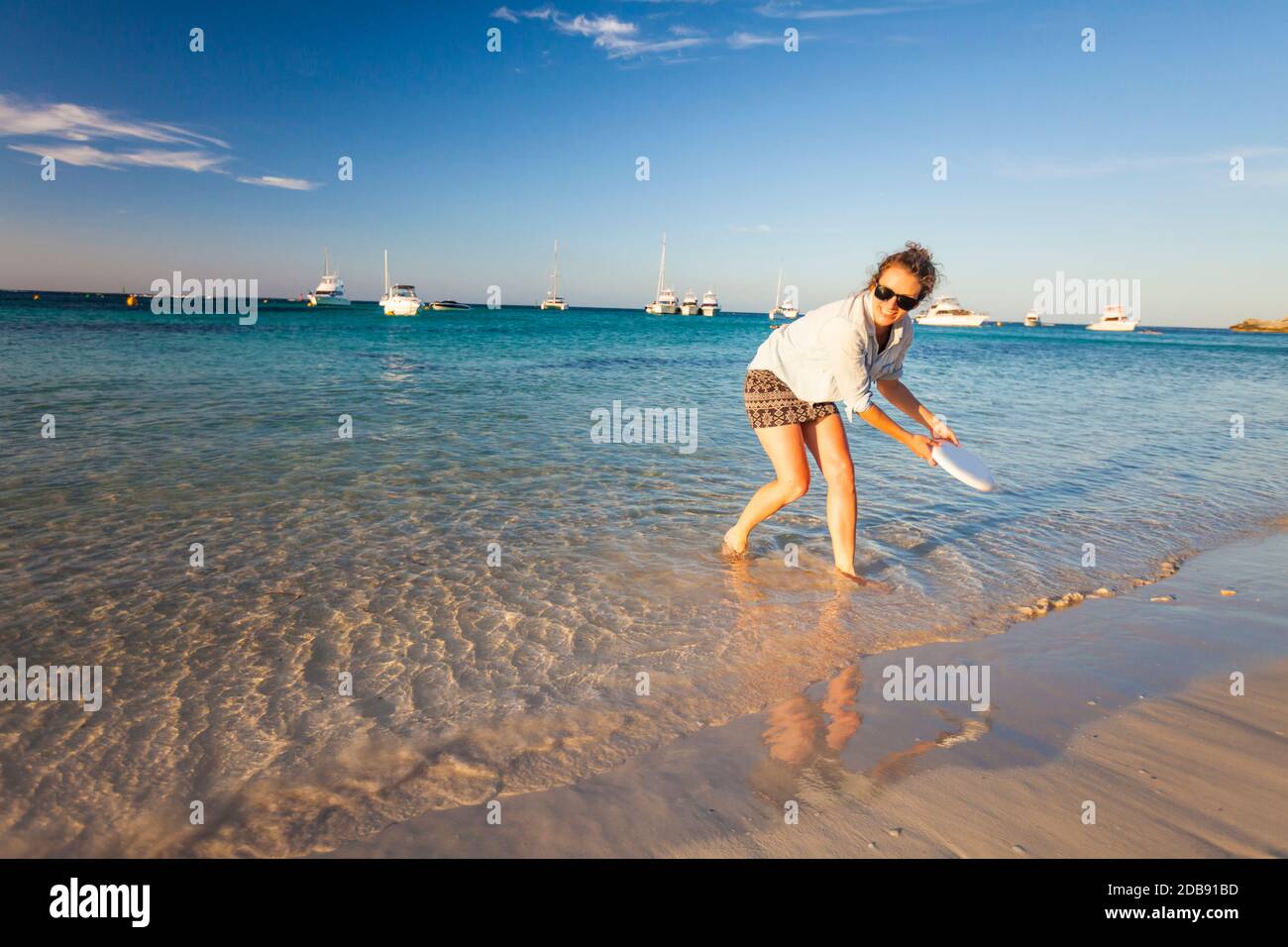 Throwing a frisbee on the beach, Rottnest Island, Australia Stock Photo ...