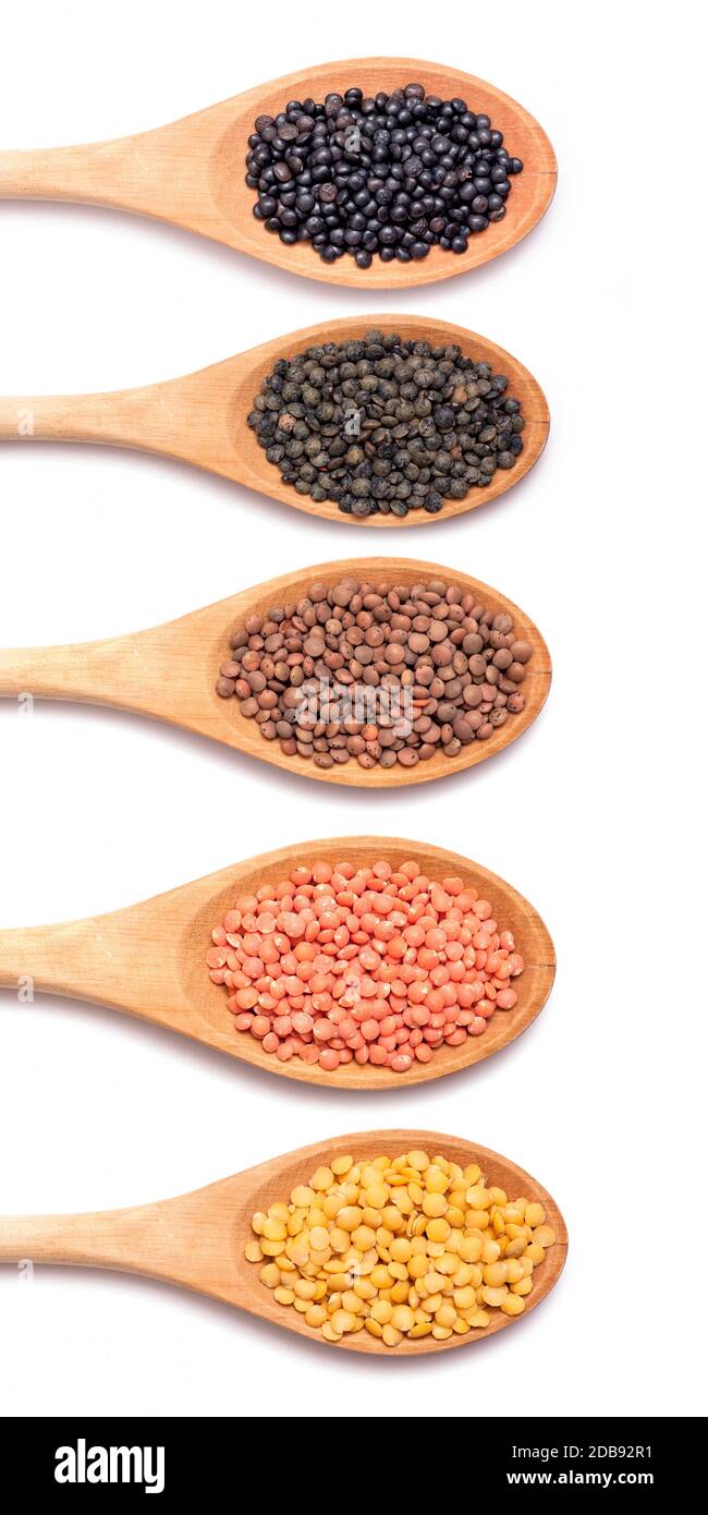 Display of different lentils on wooden spoon white isolated Stock Photo - Alamy