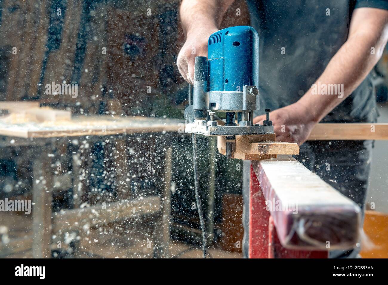 Milling wood in the joinery using manual mechanical cutters. Flying ...
