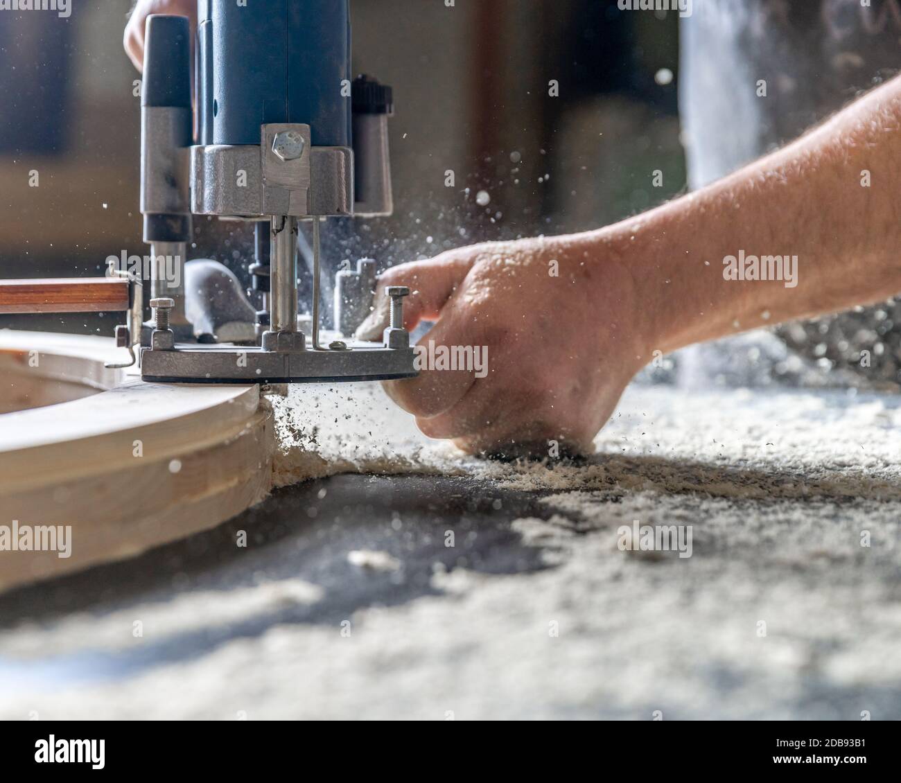 Milling wood in the joinery using manual mechanical cutters. Flying ...