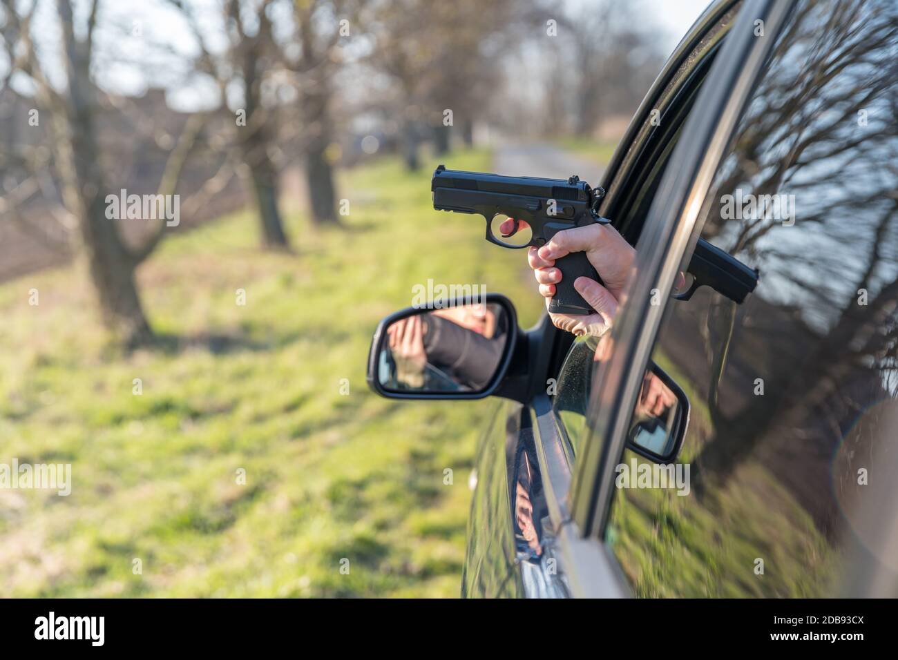 man aiming his gun from the window of a passenger car Stock Photo - Alamy