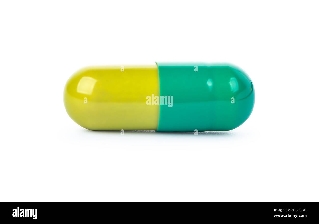 Green capsule isolated on a white background Stock Photo - Alamy