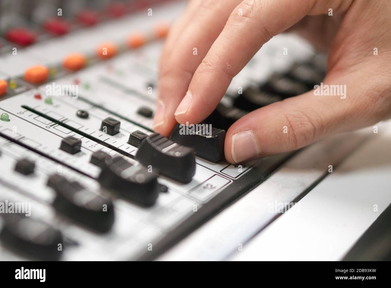 Male hand on control Fader on console. Sound recording studio mixing ...
