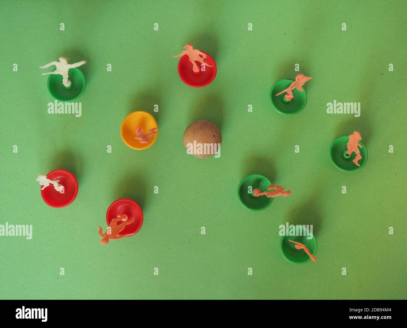 plastic toy soccer players playing football sport with wooden ball ...