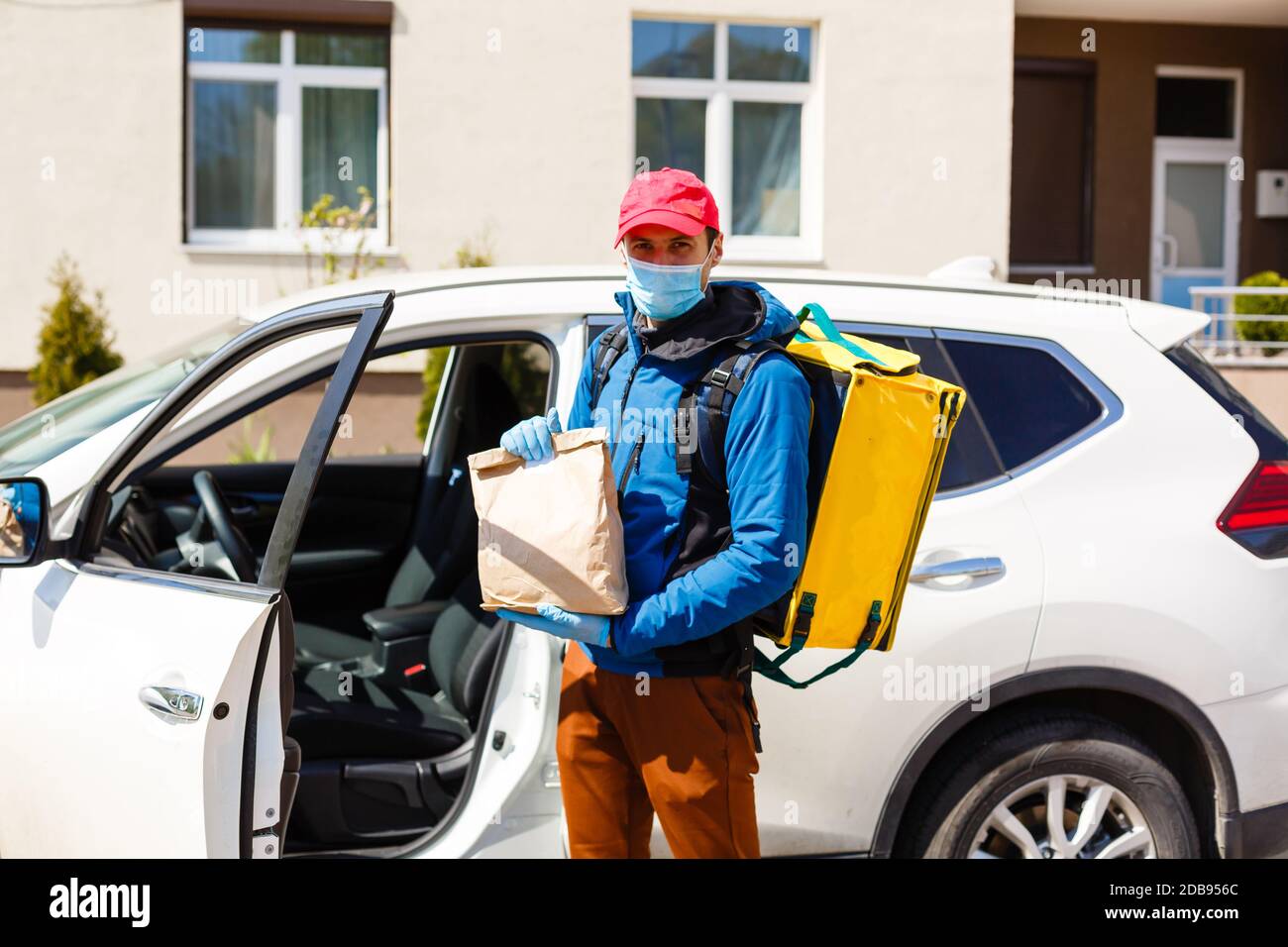 contactless food delivery to customers home. Delivery service worker ...