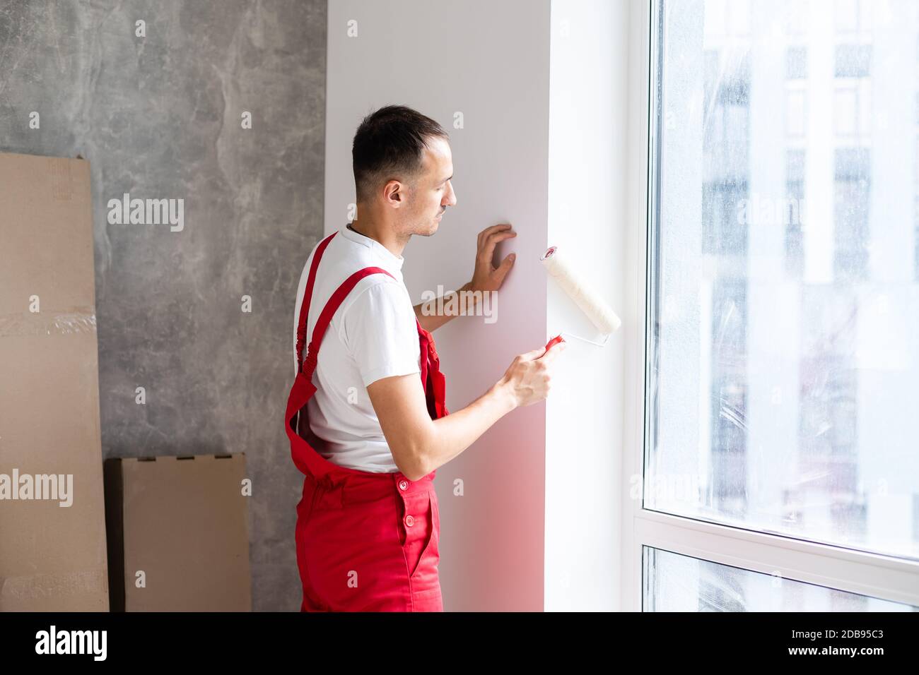 Man painting the wall, master wall painter Stock Photo - Alamy
