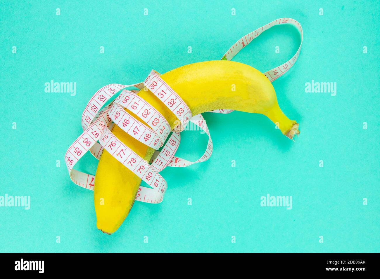 Banana with tape for measuring figure. Centimeter ruler spinned around ...
