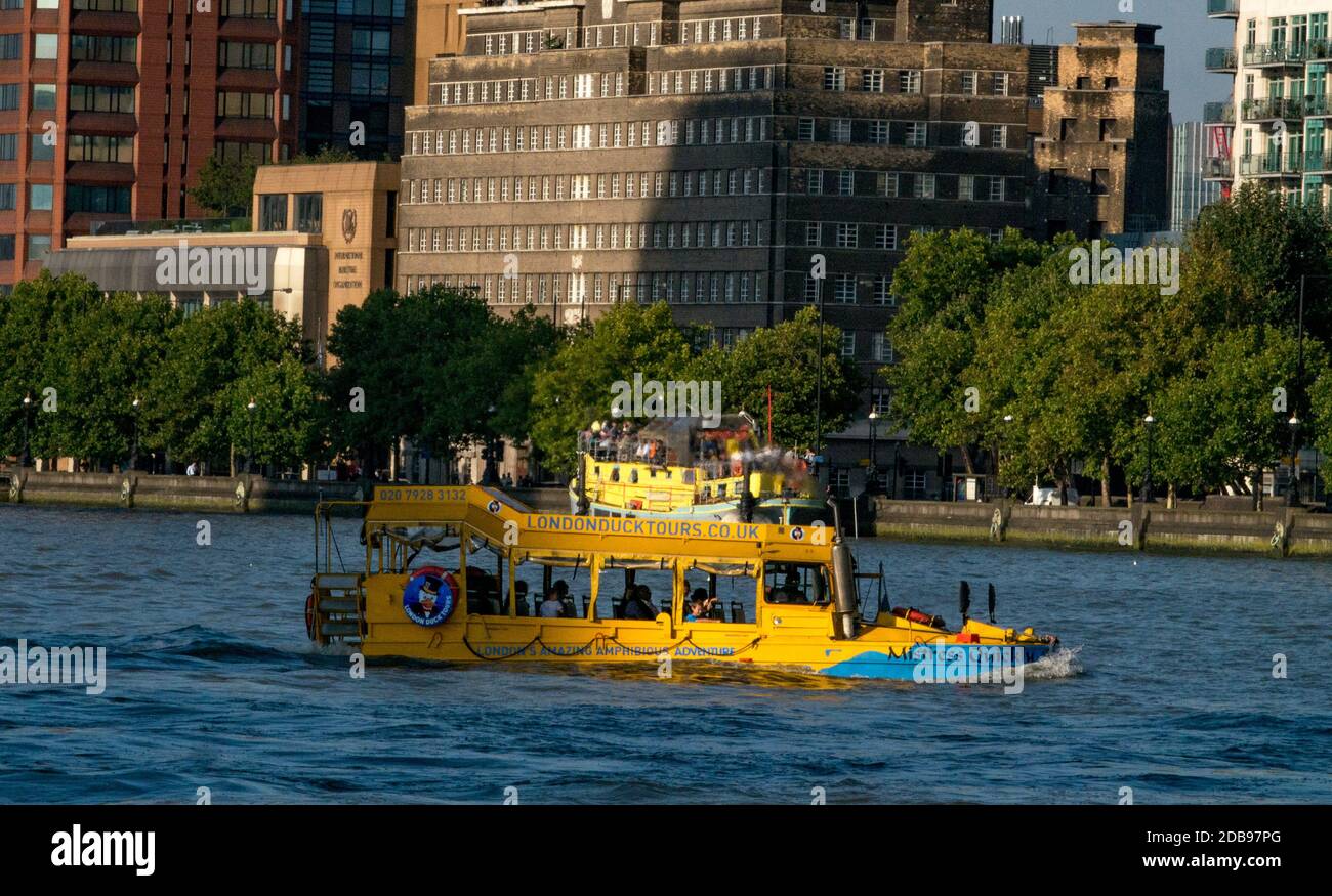London Duck Tours on the River Thames carrying tourists in London. DUKW ...