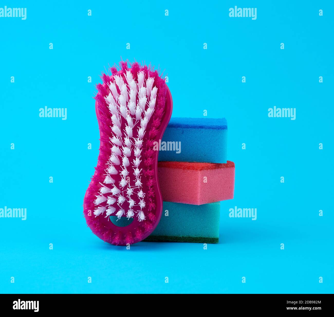 stack of multi-colored kitchen sponges for washing dishes and a red ...