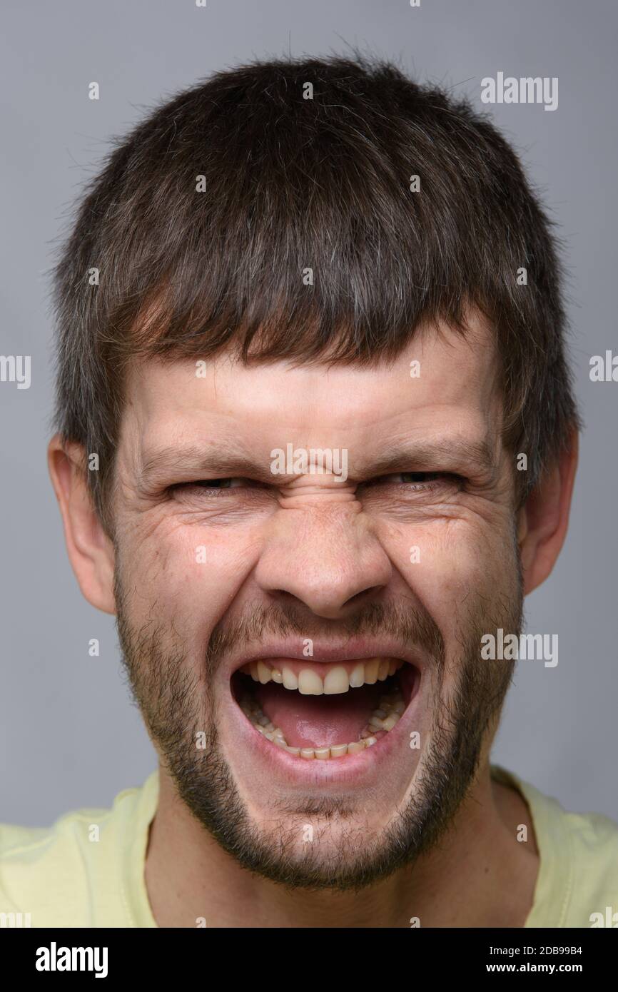 Portrait of a man of European appearance, experiencing severe pain ...