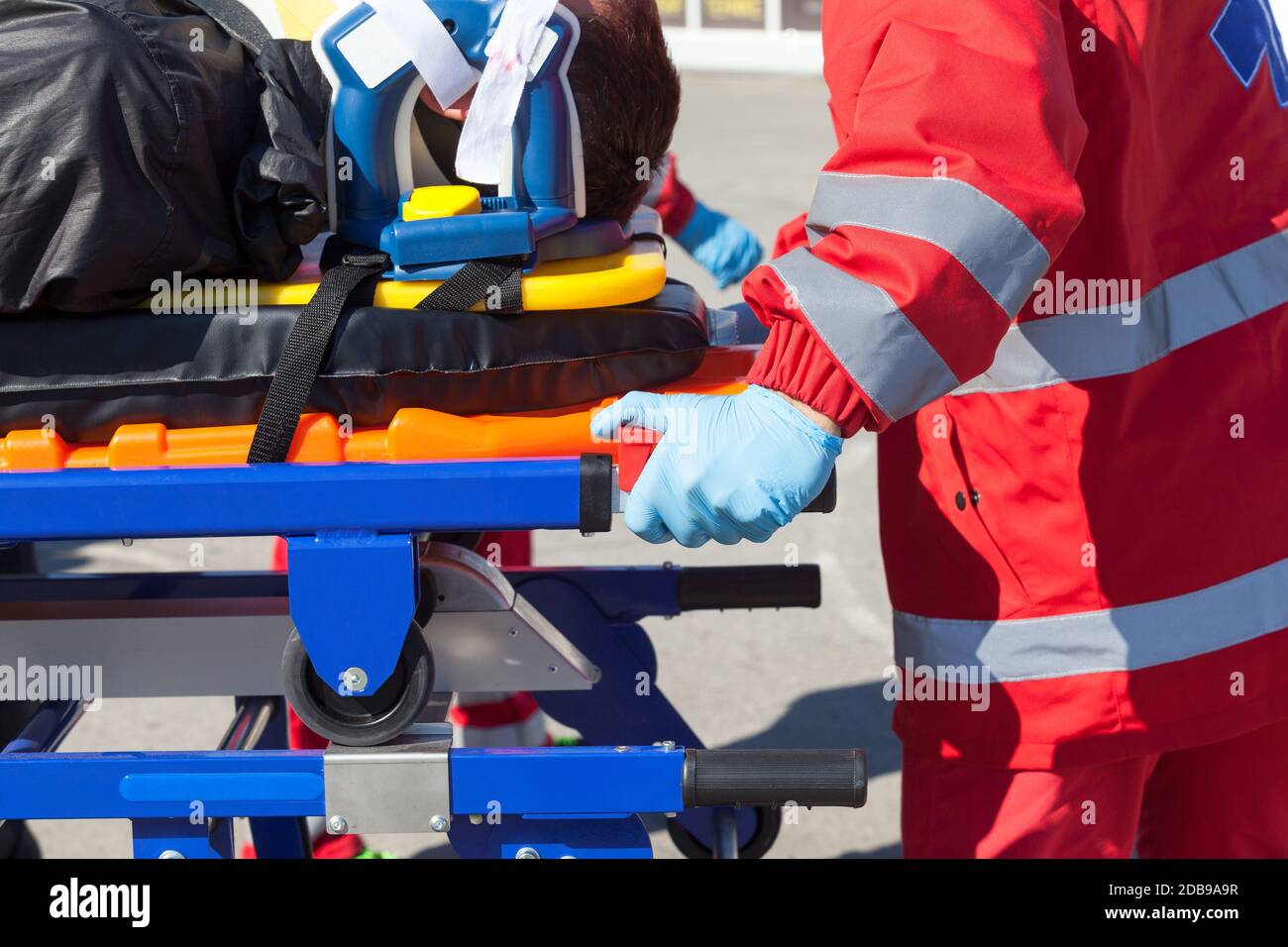 Paramedic rushing victim into ambulance Stock Photo - Alamy