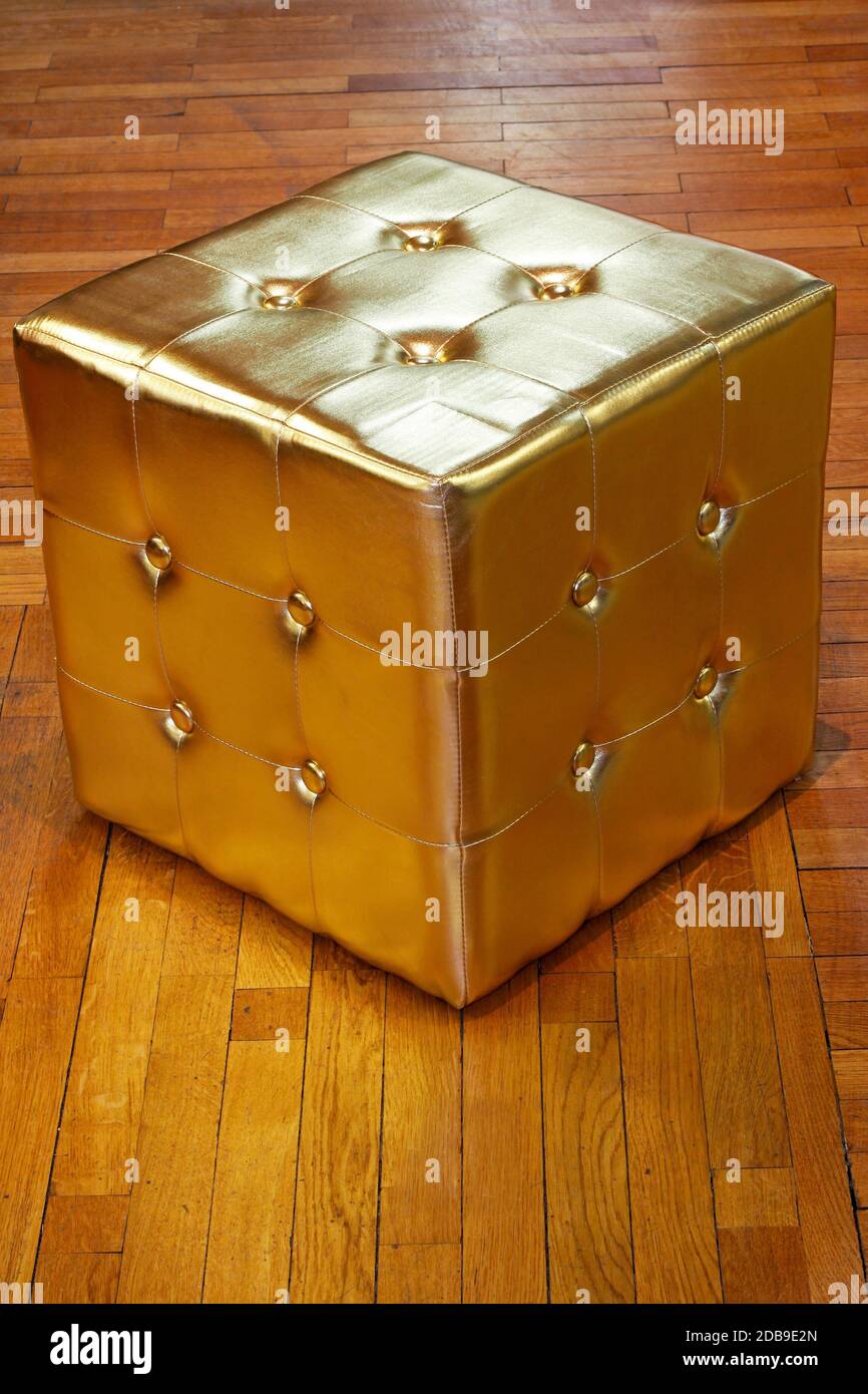 Small golden cube footstool at parquet floor Stock Photo - Alamy