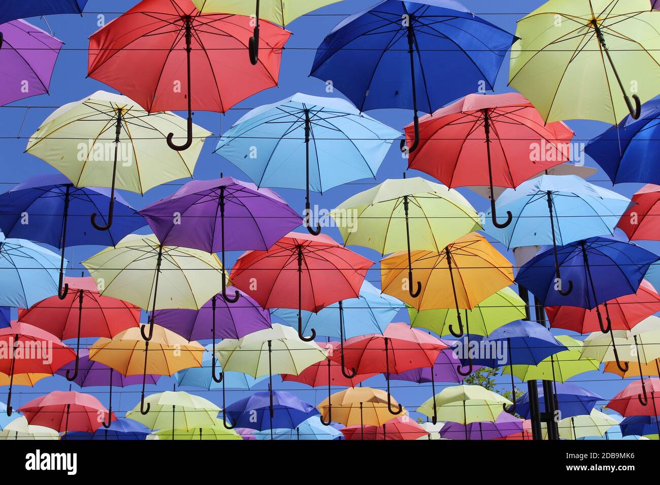 Colorful umbrellas flying in the blue sky. Summer Stock Photo - Alamy