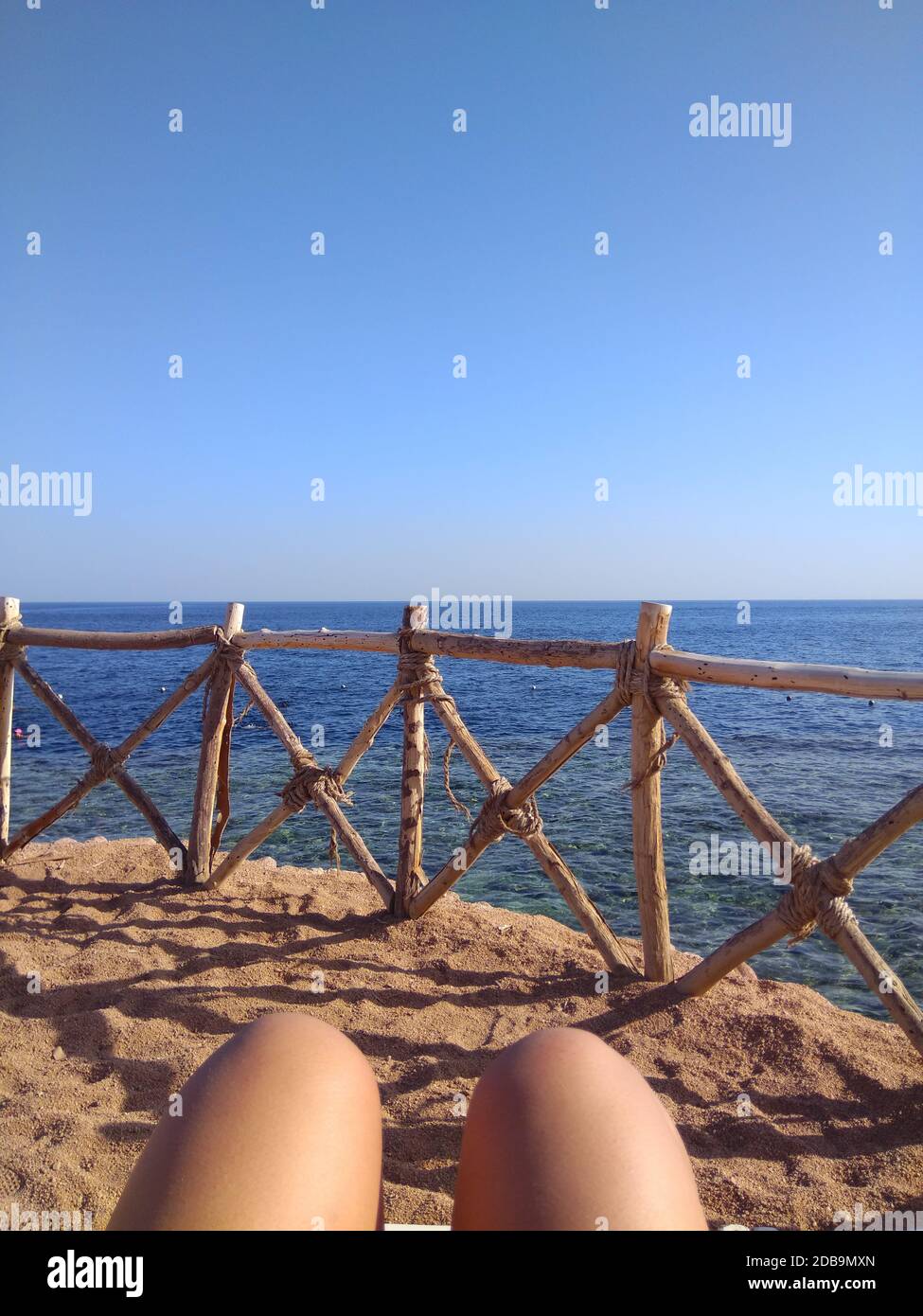 Beautiful female legs on the beach near the sea Stock Photo - Alamy