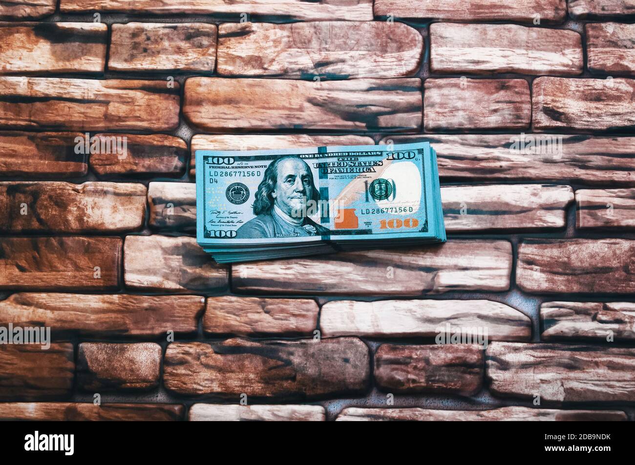 A pack of dollars.A large wad of hundred-dollar bills is lying on a ...