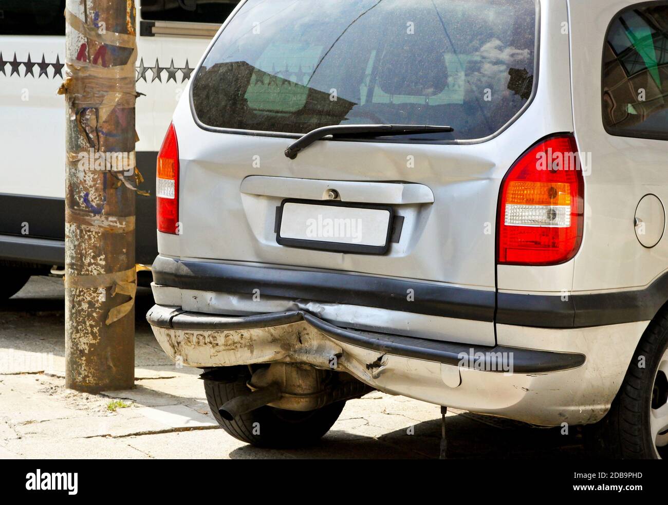 Damaged minivan bumper after hitting a light pole Stock Photo - Alamy