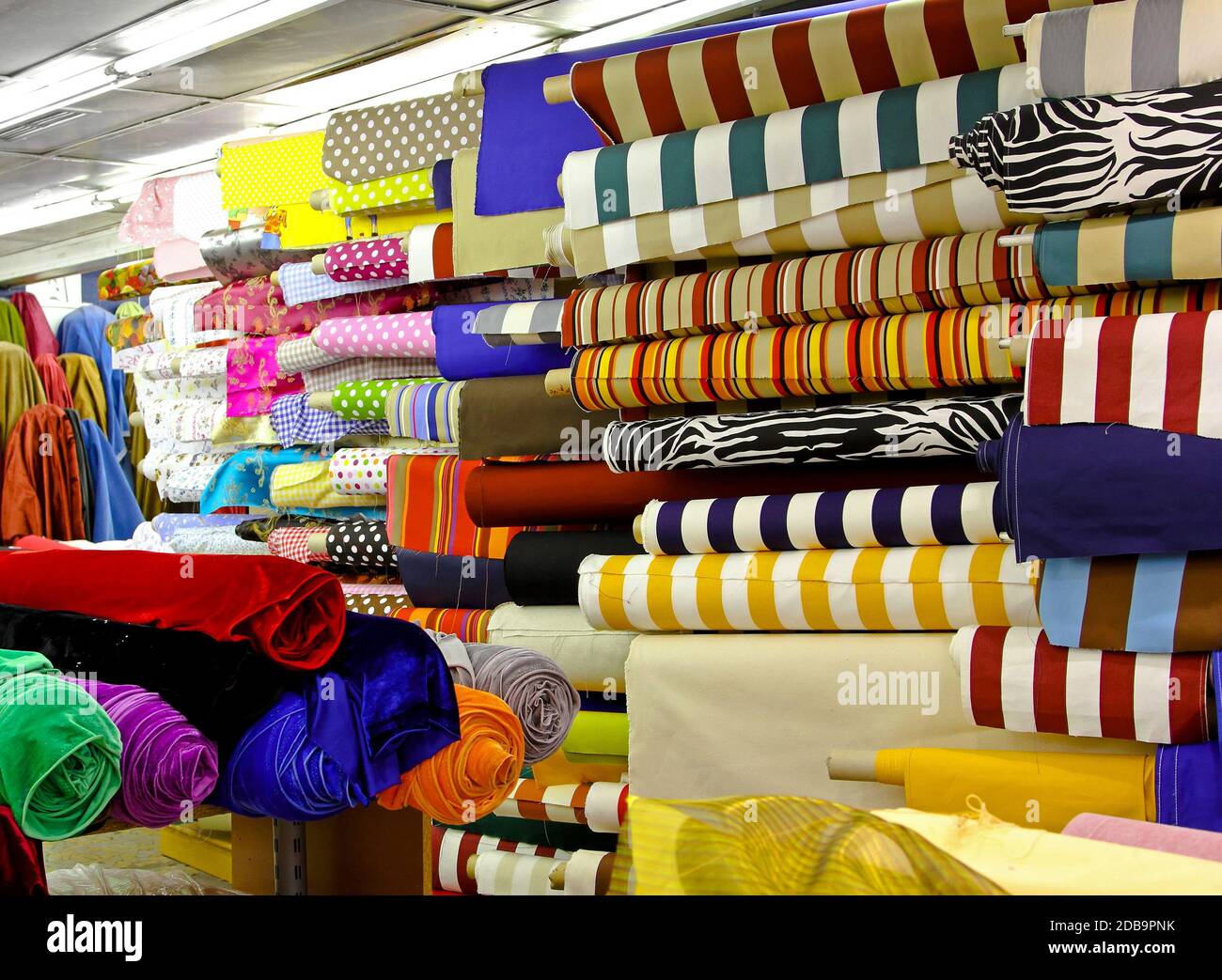 Colorful textile fabric material rolls for fashion Stock Photo - Alamy