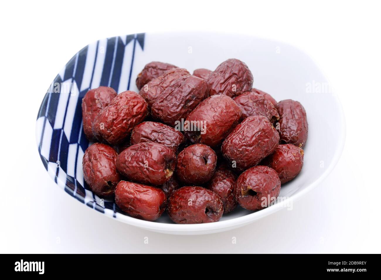 Jujube, Chinese dried red date fruits in a bowl on white background ...