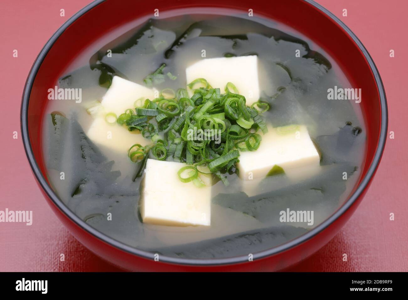 Japanese food, Miso soup of tofu and seaweed wakame in a bowl on table Stock Photo - Alamy