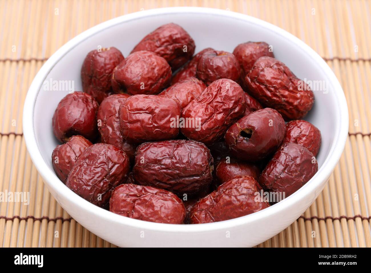 Dried Jujube, Chinese dried red date fruits in a bowl on bamboo table ...