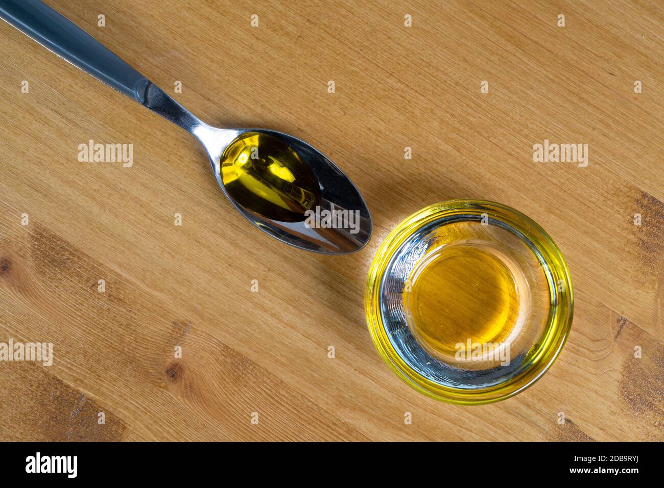 a spoon and a glass container with olive oil Stock Photo - Alamy