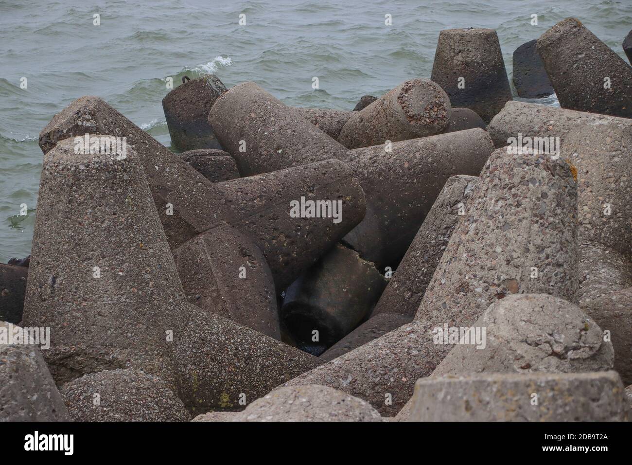 Tetrapods along the waterfront sea wall, port breakwater concrete Stock ...