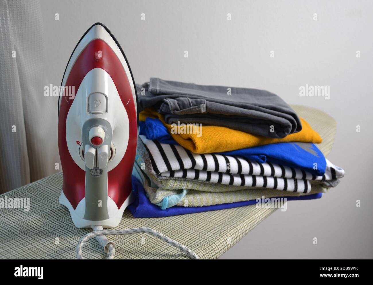an iron with ironed laundry Stock Photo - Alamy