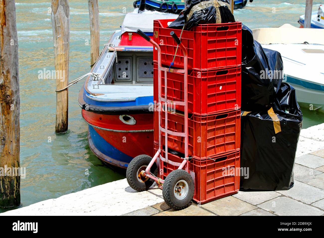 Delivery cart with red crates in Venice Stock Photo - Alamy