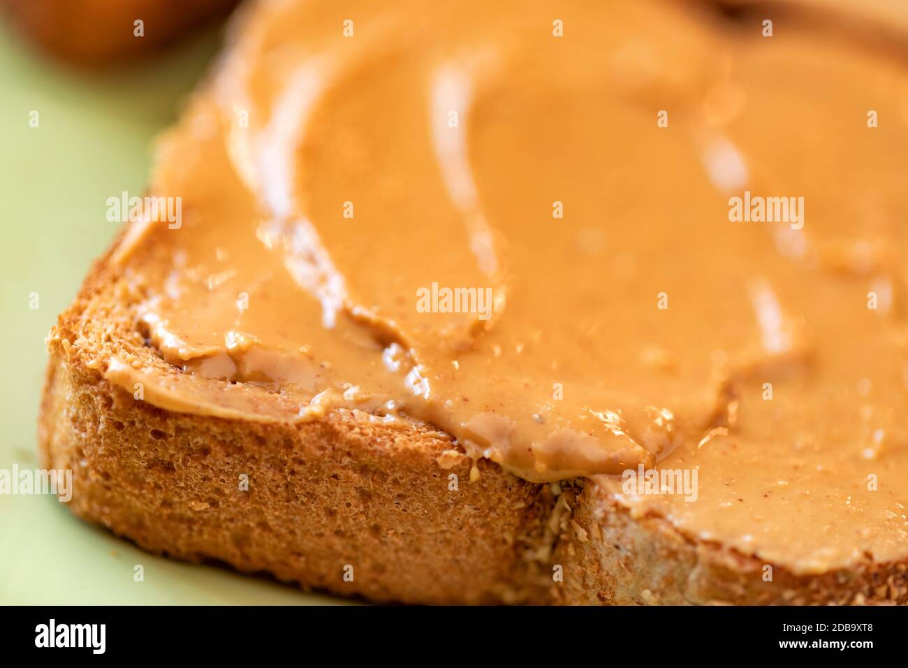 Creamy peanut butter spread on healthy whole wheat toast bread Stock ...
