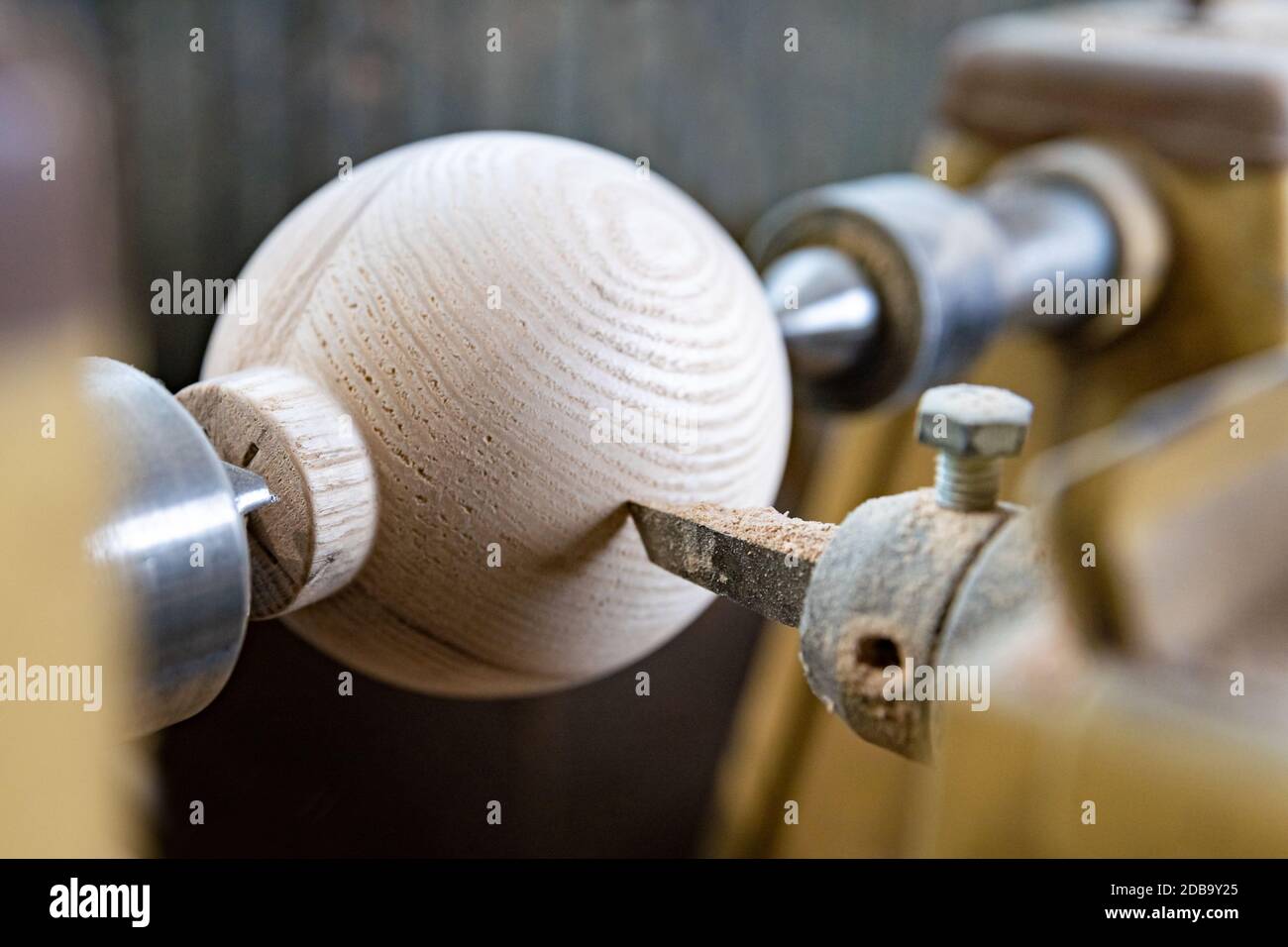 manufacture round wooden handles on lathe in joinery Stock Photo - Alamy