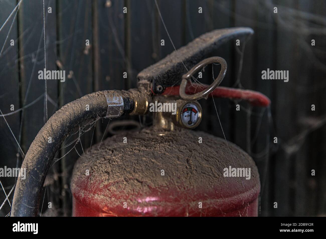 old fire extinguisher covered with dust and cobweb Stock Photo - Alamy