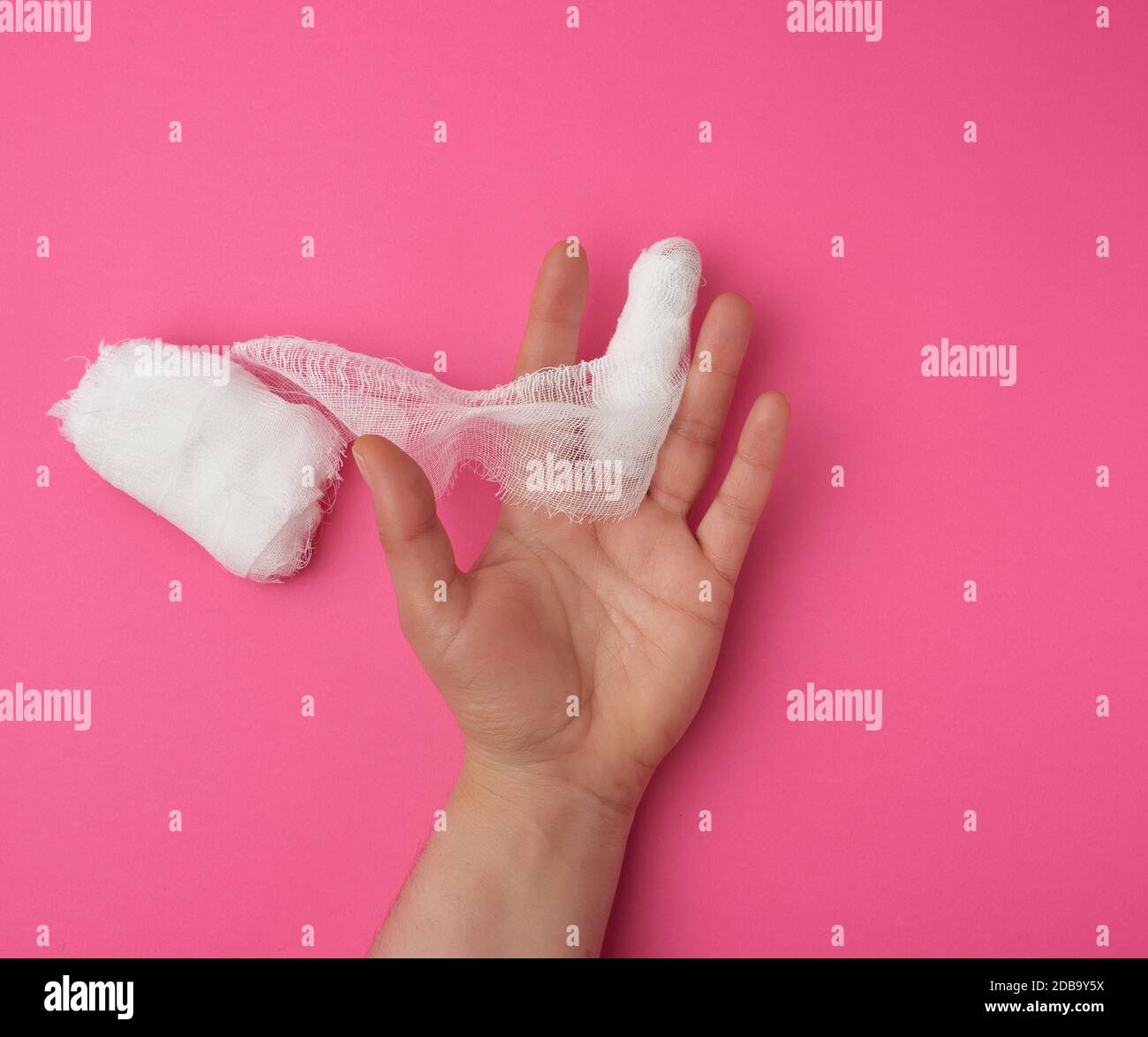 rewound middle finger with white medical sterile gauze bandage, pink ...