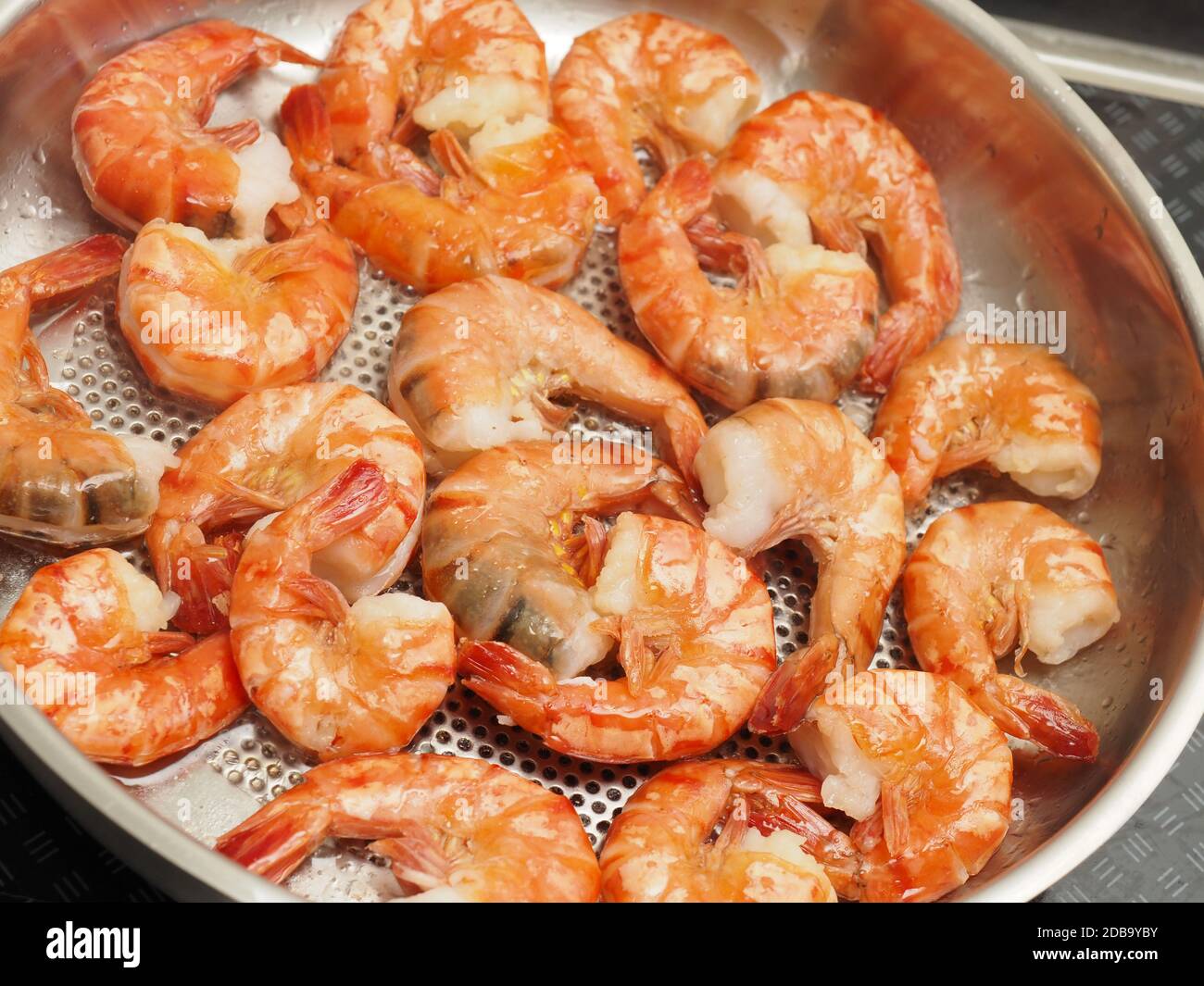 Frying organic black tiger prawns in a steel pan Stock Photo - Alamy