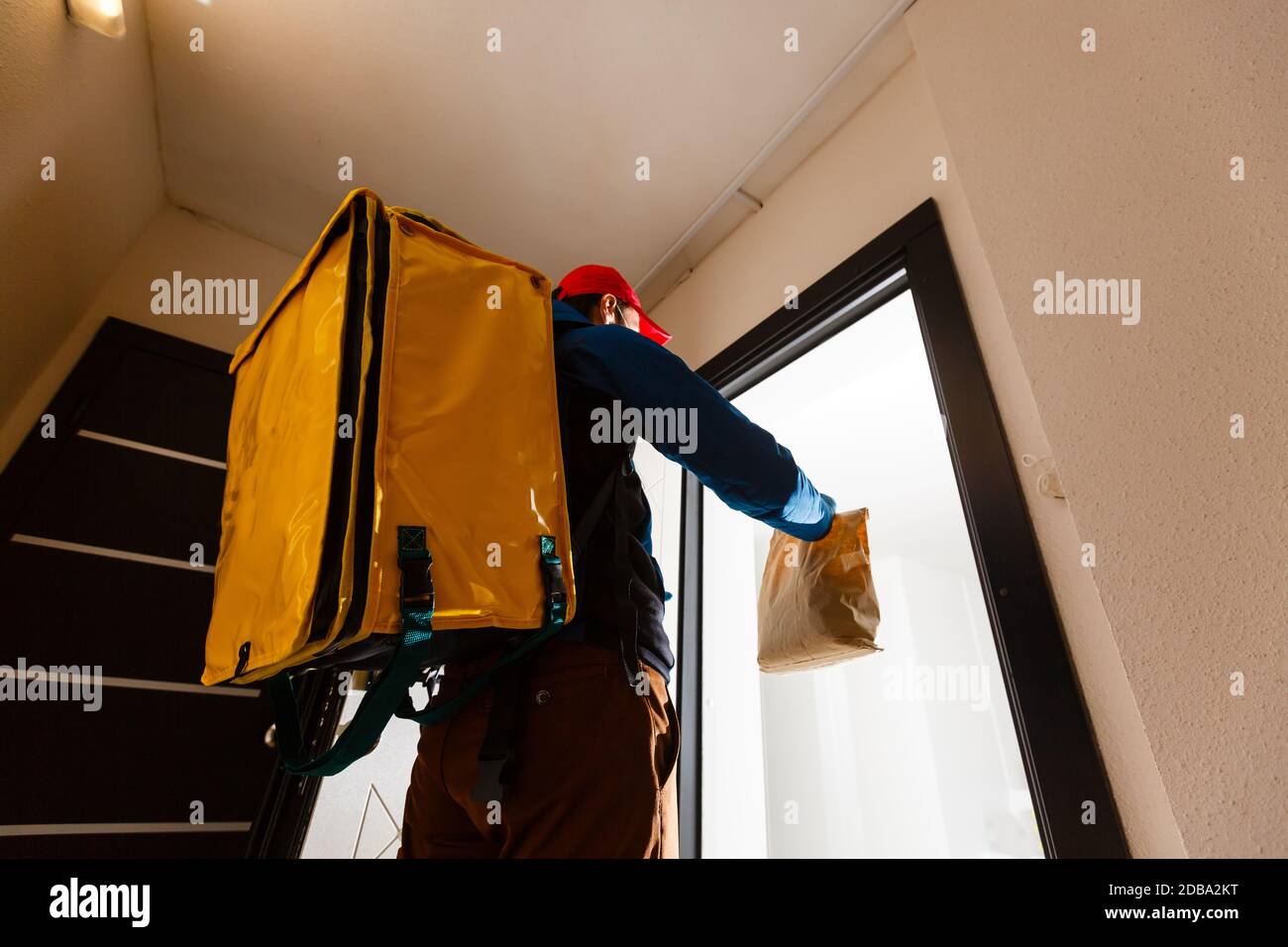 contactless food delivery to customers home. Delivery service worker ...