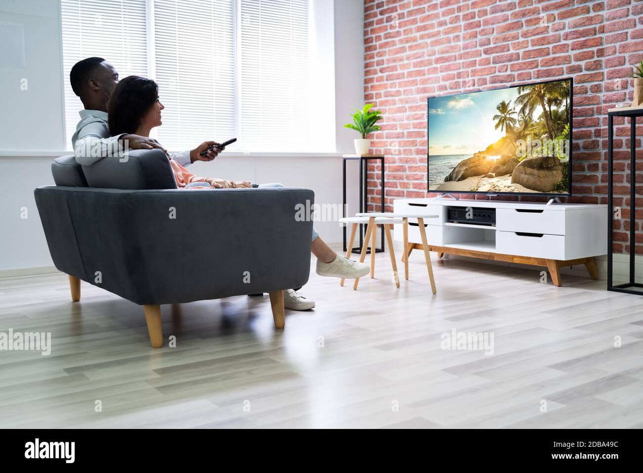 Rear View Of A Couple Watching Movie On Television At Home Stock Photo ...