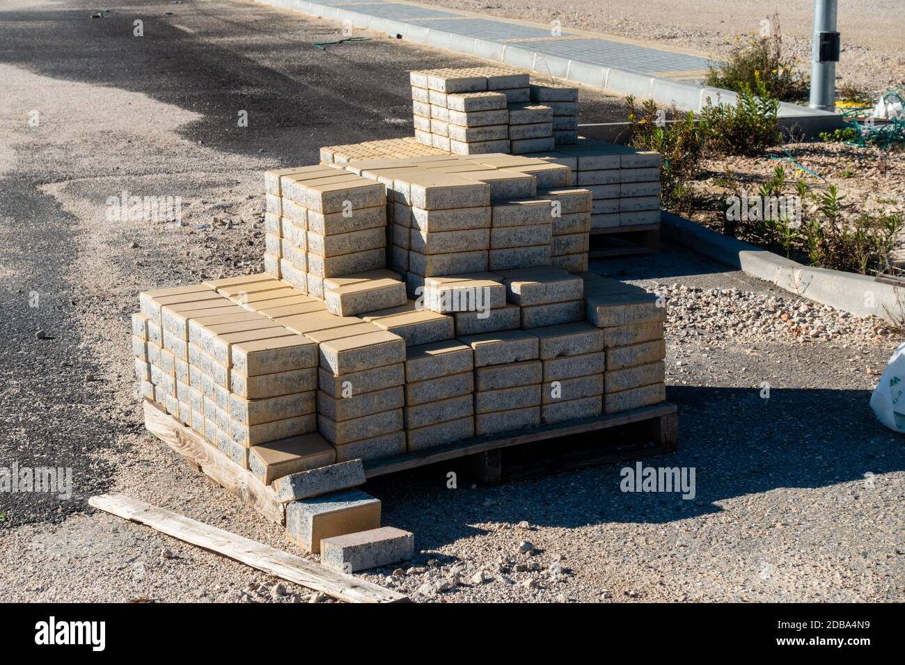 paving slabs stacked at roadside ready for use Stock Photo - Alamy
