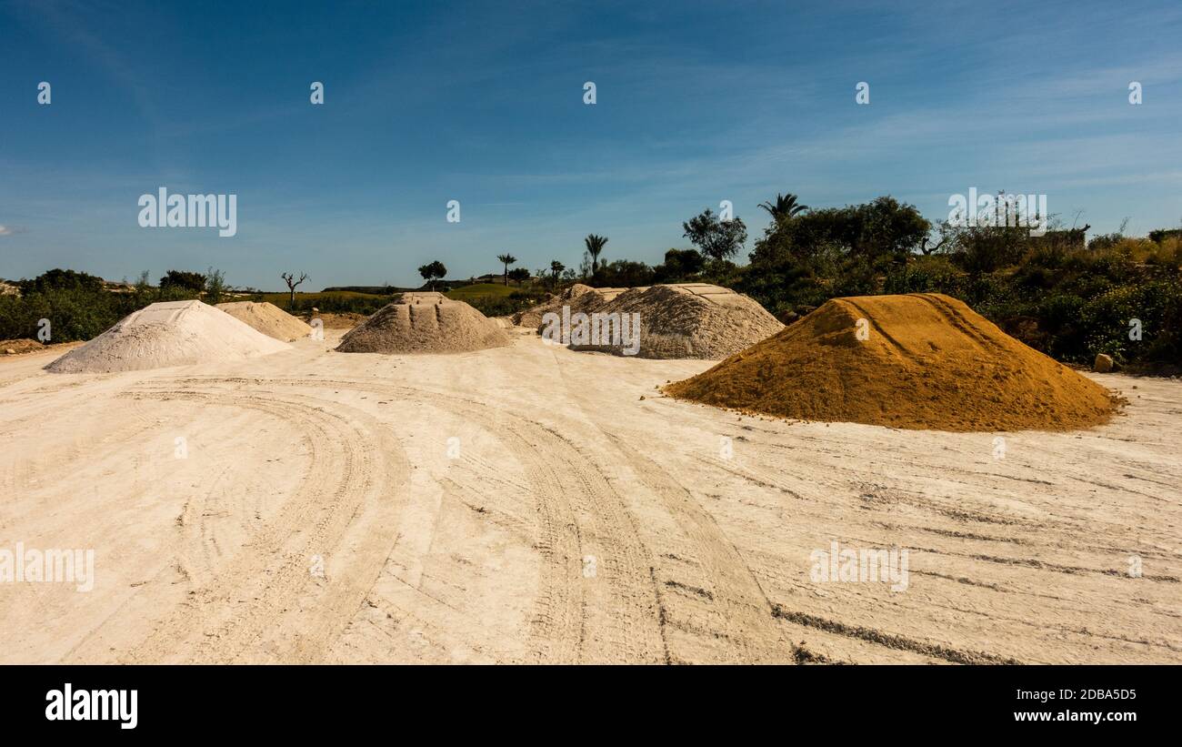 piles of sand, shingle and rubble by roadside ready for use Stock Photo ...