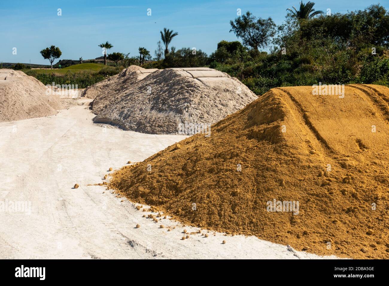 piles of sand, shingle and rubble by roadside ready for use Stock Photo ...