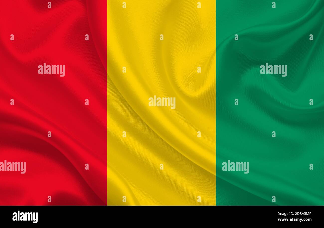 Guinea country flag on wavy silk fabric background panorama ...