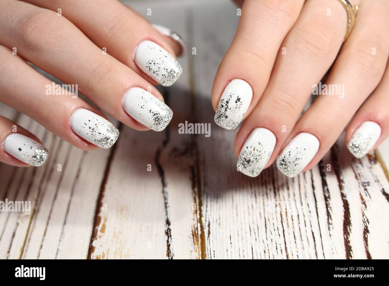 beautiful white manicure with pattern and sparkles Stock Photo - Alamy