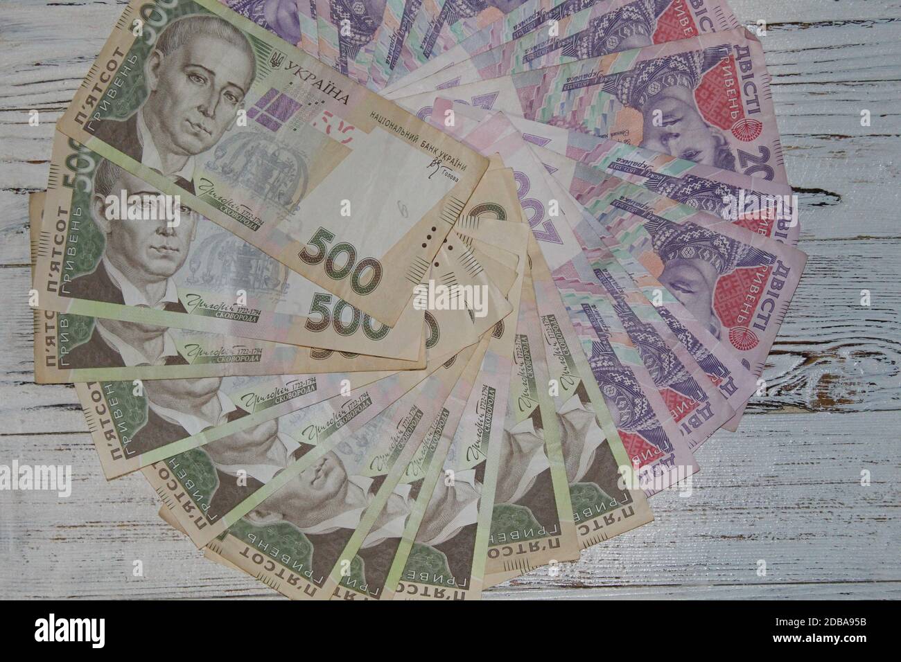 A lot of money scattered on a white table Stock Photo - Alamy