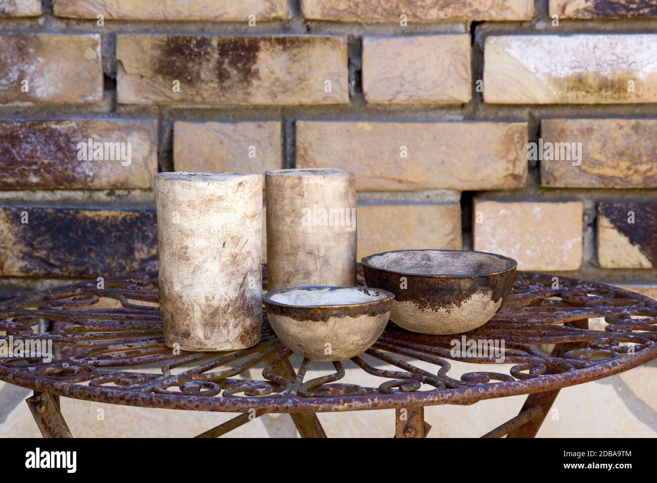 clay pots on a metal table handmade pottery Stock Photo - Alamy