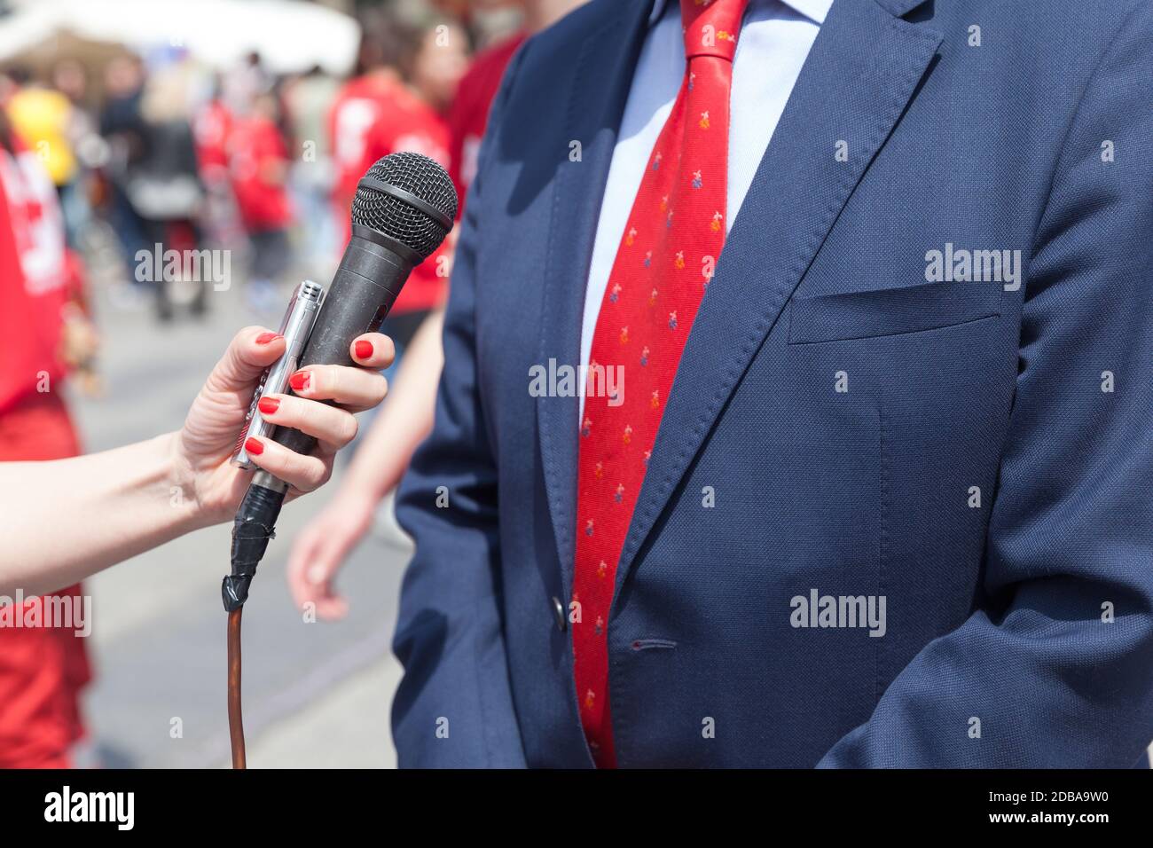 Journalist holding microphone making media interview with business ...