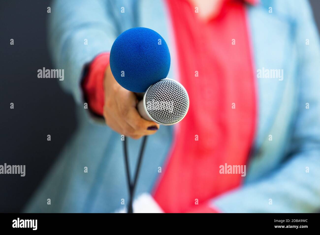 Female reporter at work, holding microphone at a press conference Stock ...