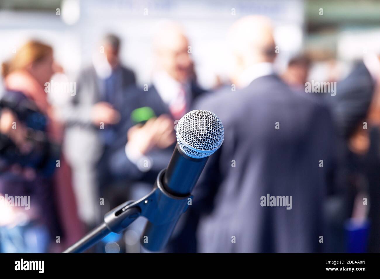 Mic in focus against blurred audience Stock Photo - Alamy