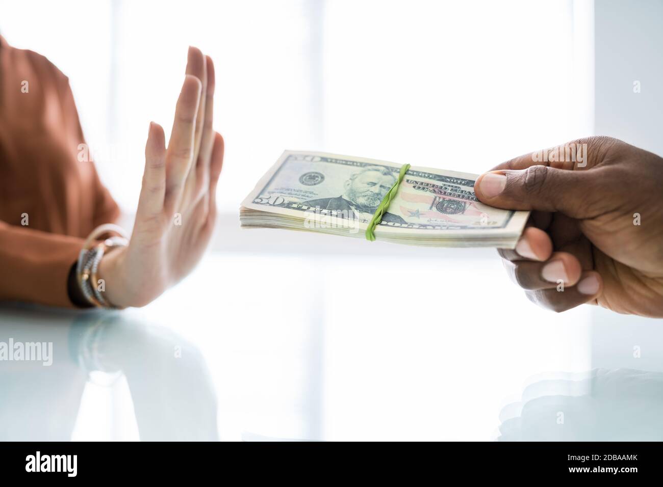Woman Hand Refusing Bribe Given By Partner At Workplace Stock Photo - Alamy