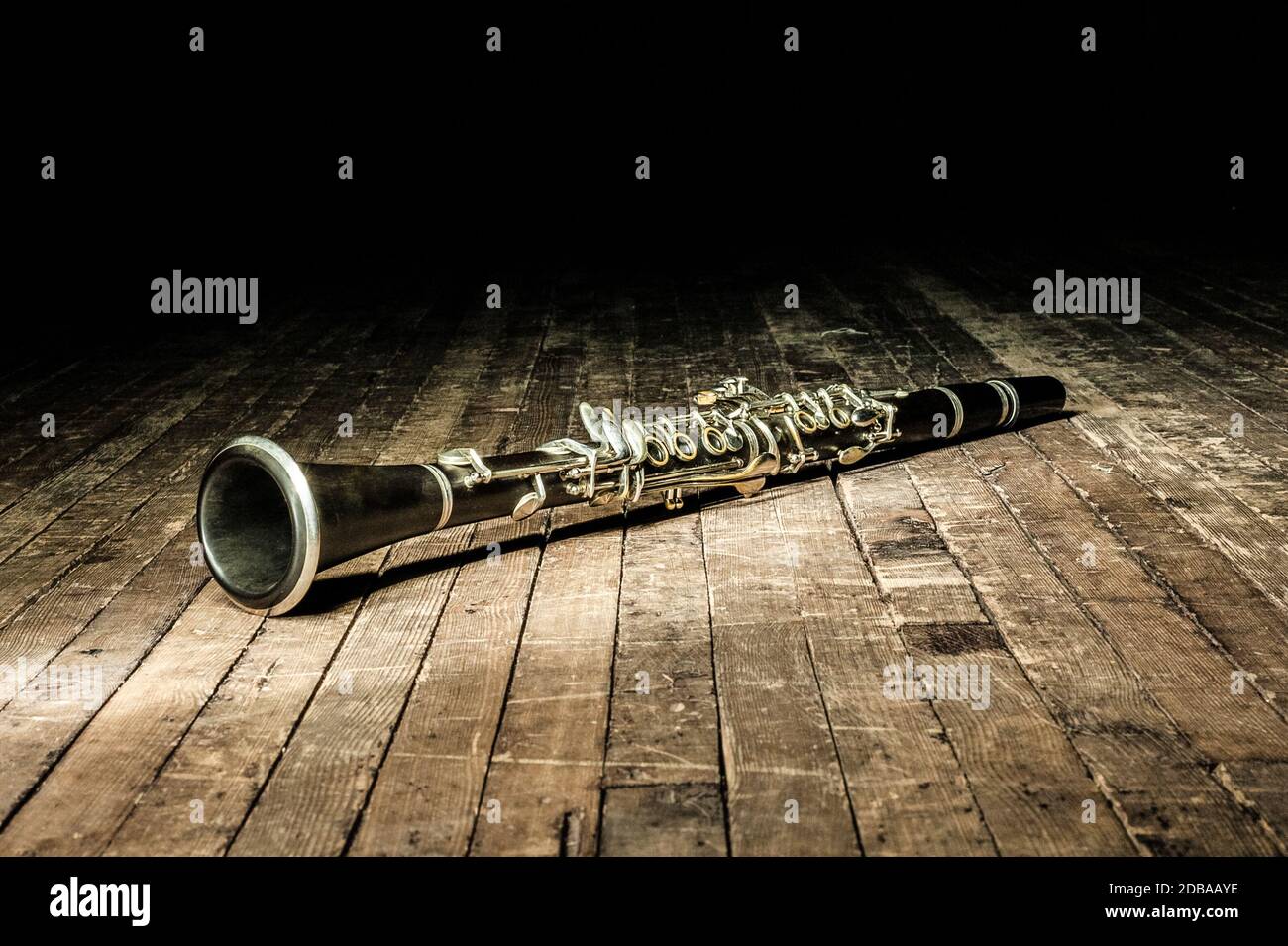 black woodwind clarinet lies on a brown wooden stage Stock Photo - Alamy