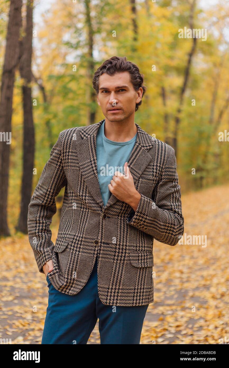 Tall handsome man on the autumn alley Stock Photo - Alamy