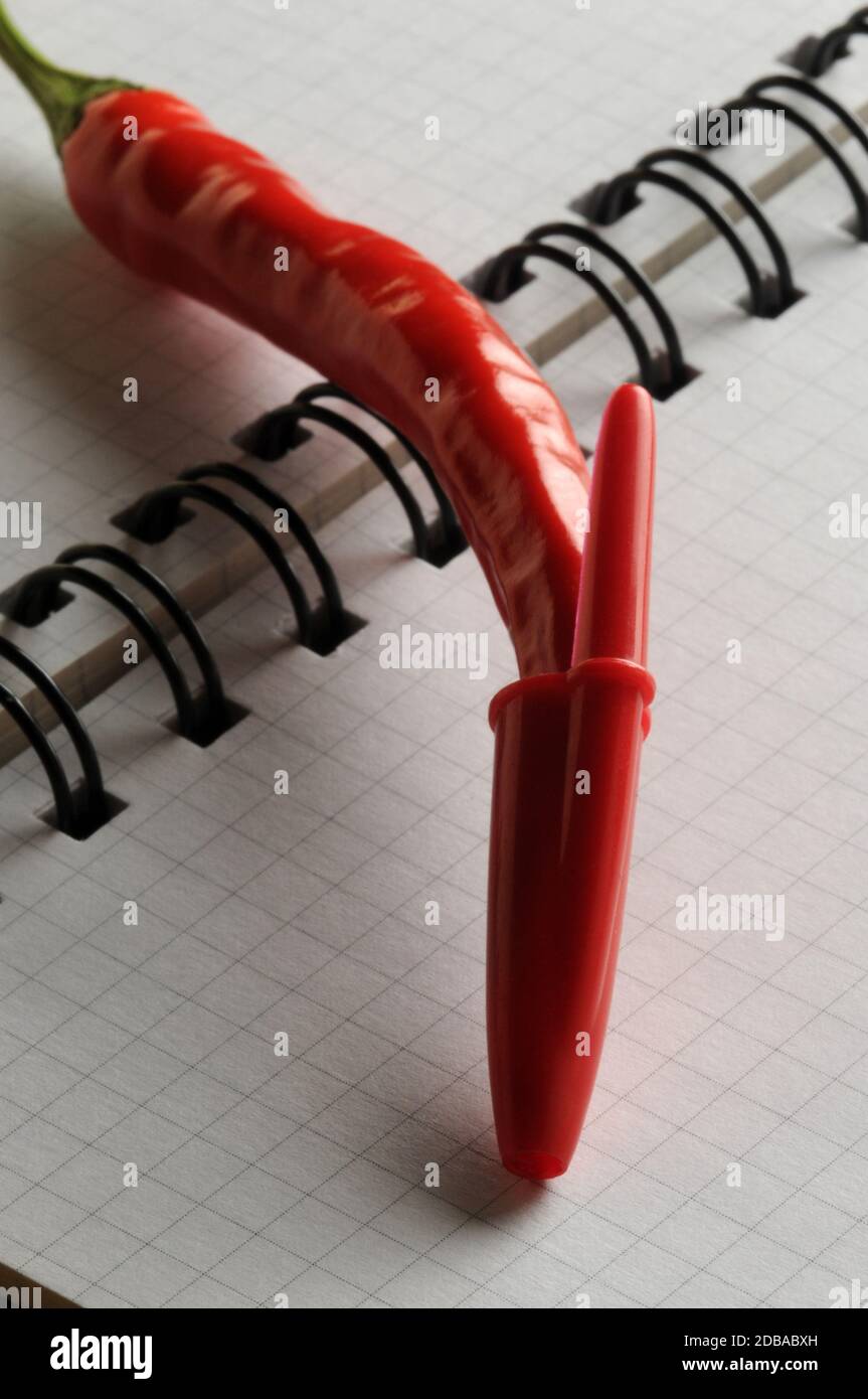 Cap of a red pen on hot pepper Stock Photo - Alamy