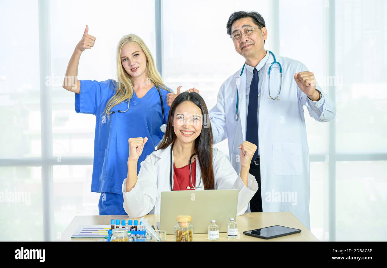 Group of doctors wearing formal white coat and blue scrubs suit, Thumbs ...